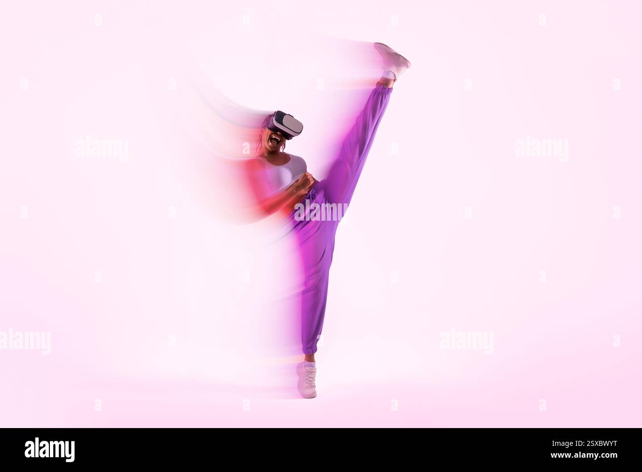 African American woman throwing kick in immersive virtual reality game ...