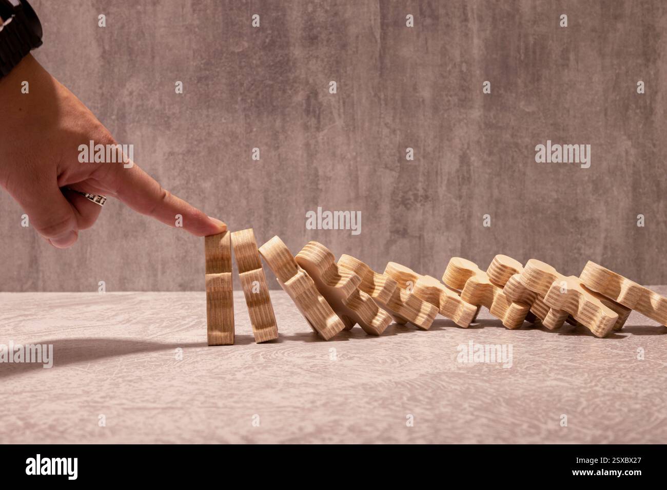 insurance with hands protect domino. Businessman hands stop dominoes ...