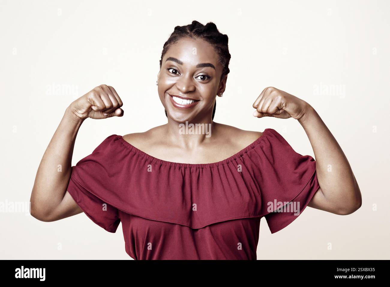 Strong african american woman showing off her muscles Stock Photo - Alamy