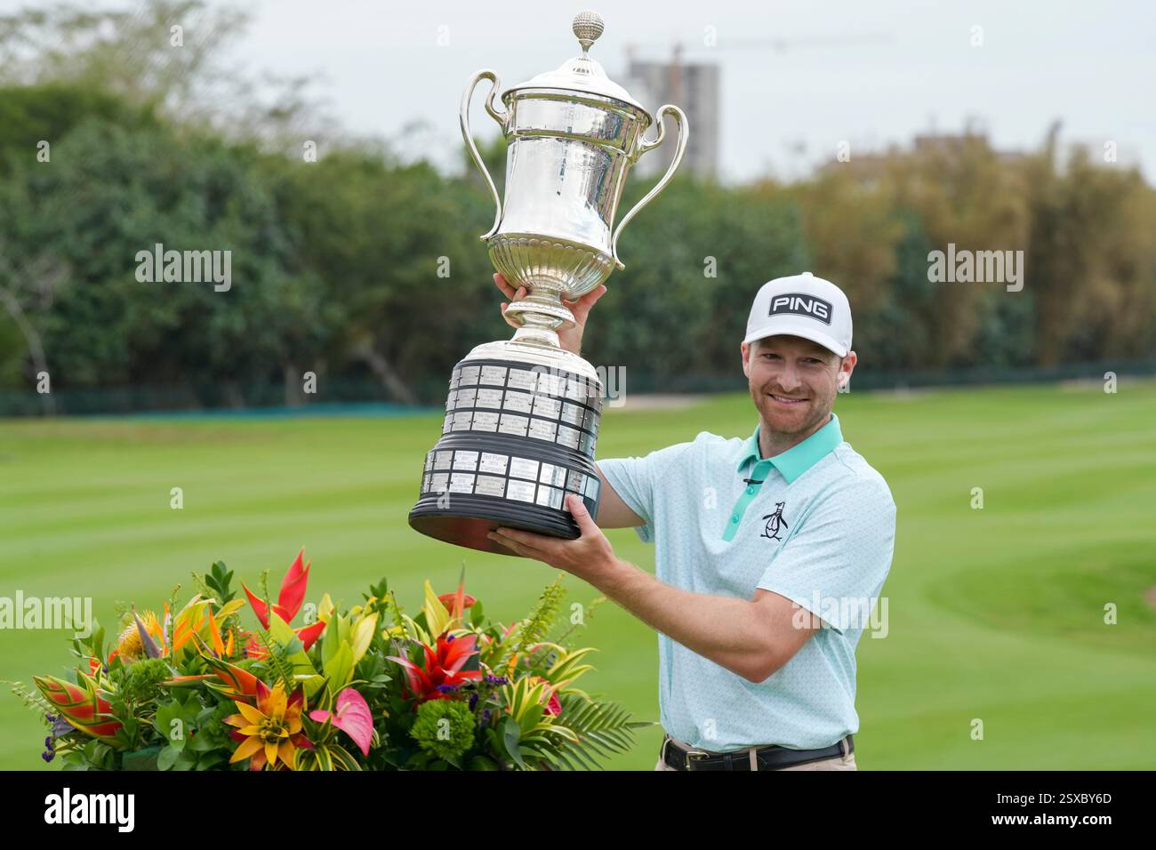 Brian Campbell, of the United States, holds the championship trophy ...