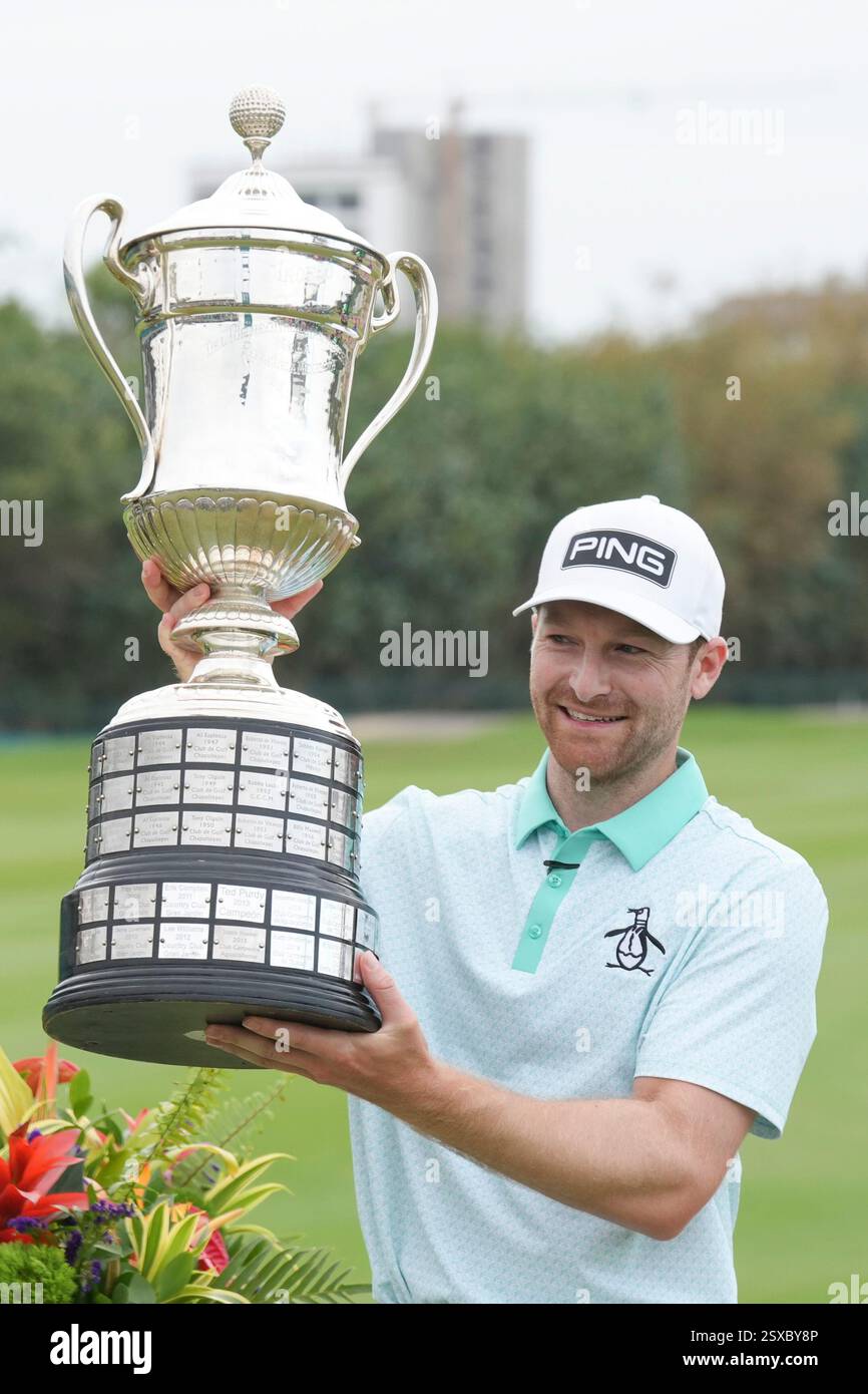 Brian Campbell, of the United States, holds the championship trophy ...