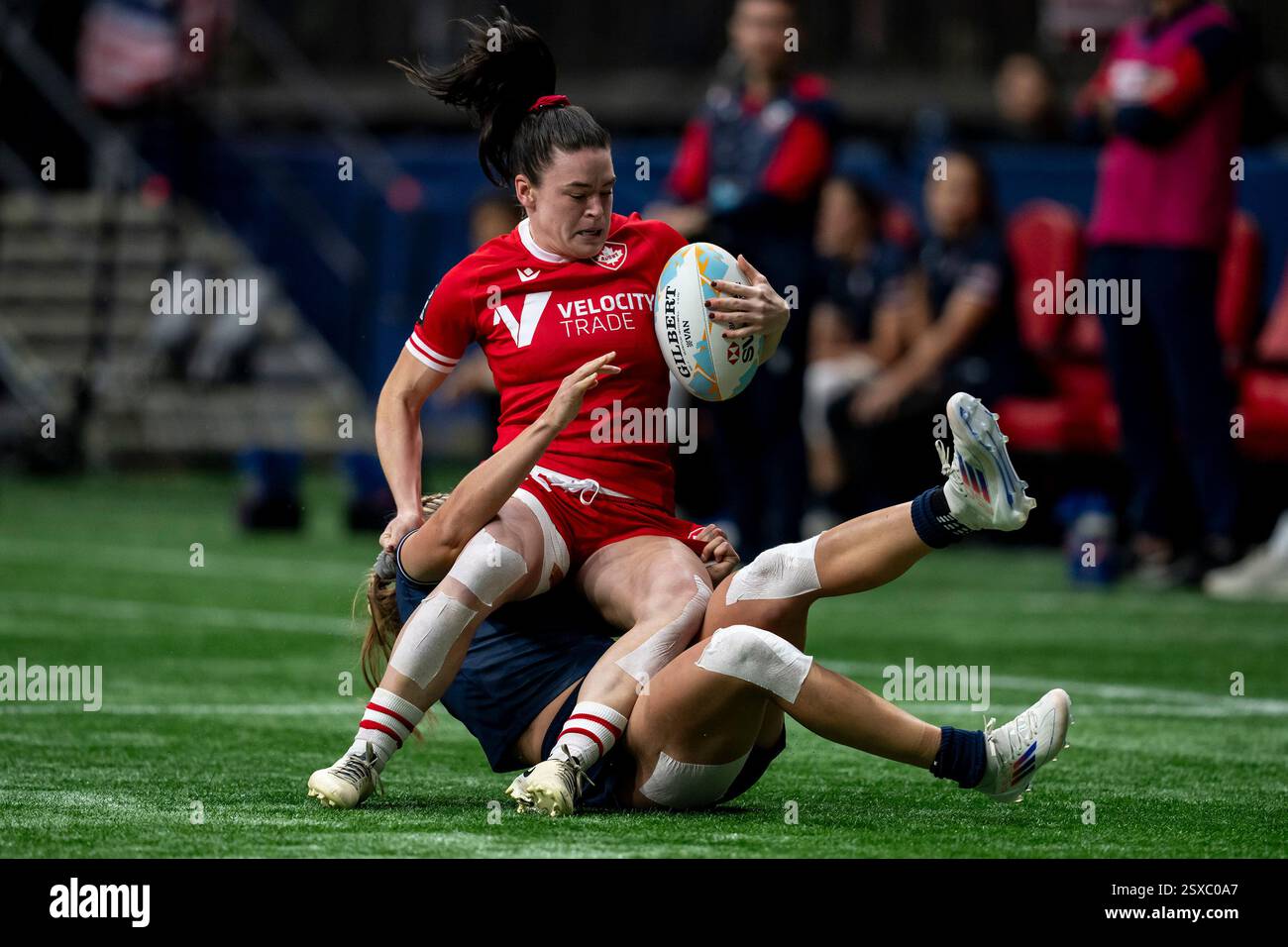 Canada's Alysha Corrigan, top, is tackled by United States' Tessa Hann ...