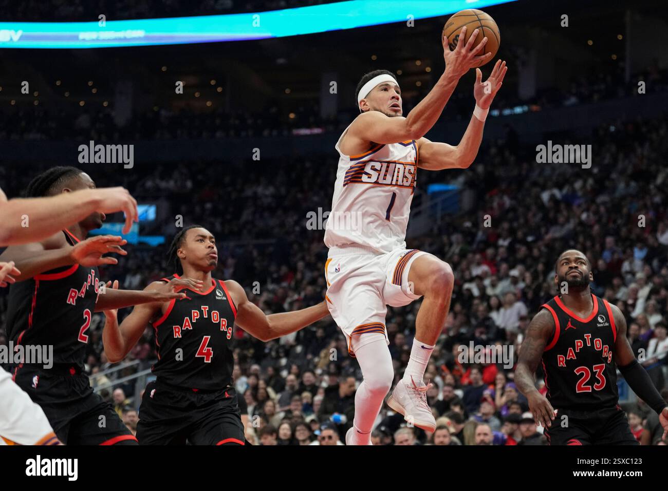 Phoenix Suns guard Devin Booker (1) jumps to shoot as Toronto Raptors forward Scottie Barnes (4 ...