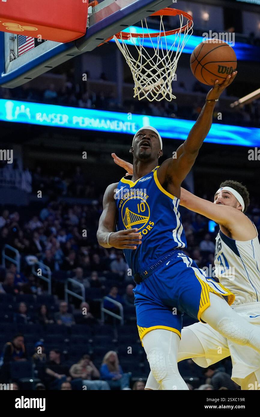 Golden State Warriors forward Jimmy Butler III, left, shoots next to ...