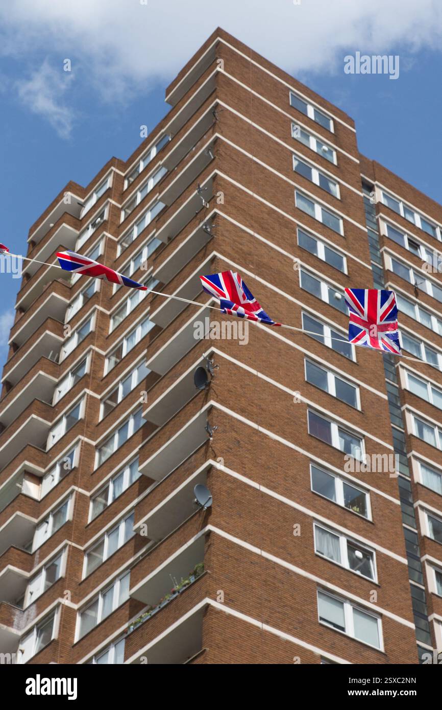 Union Jack flags strung between balconies of a high-rise building in ...