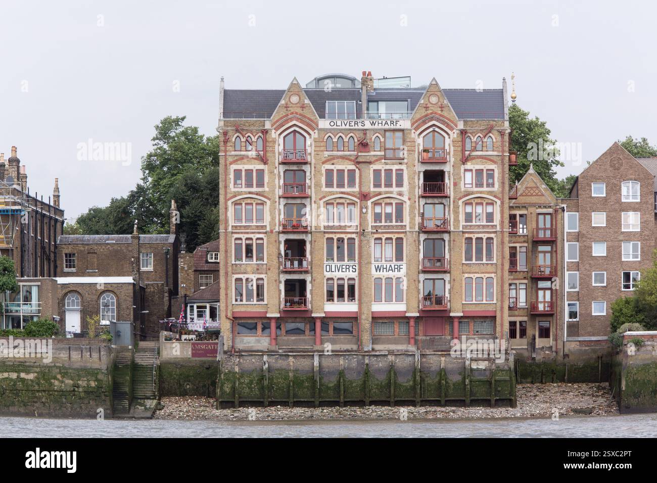 Oliver's Wharf, London, UK. Multi-story brick building on the Thames ...