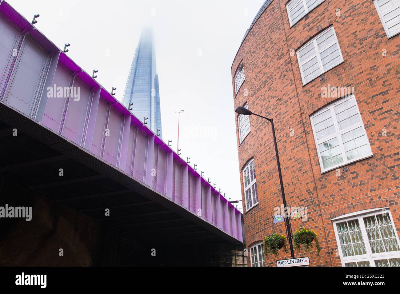 Purple-painted bridge structure over Magdalen Street, London, with the ...