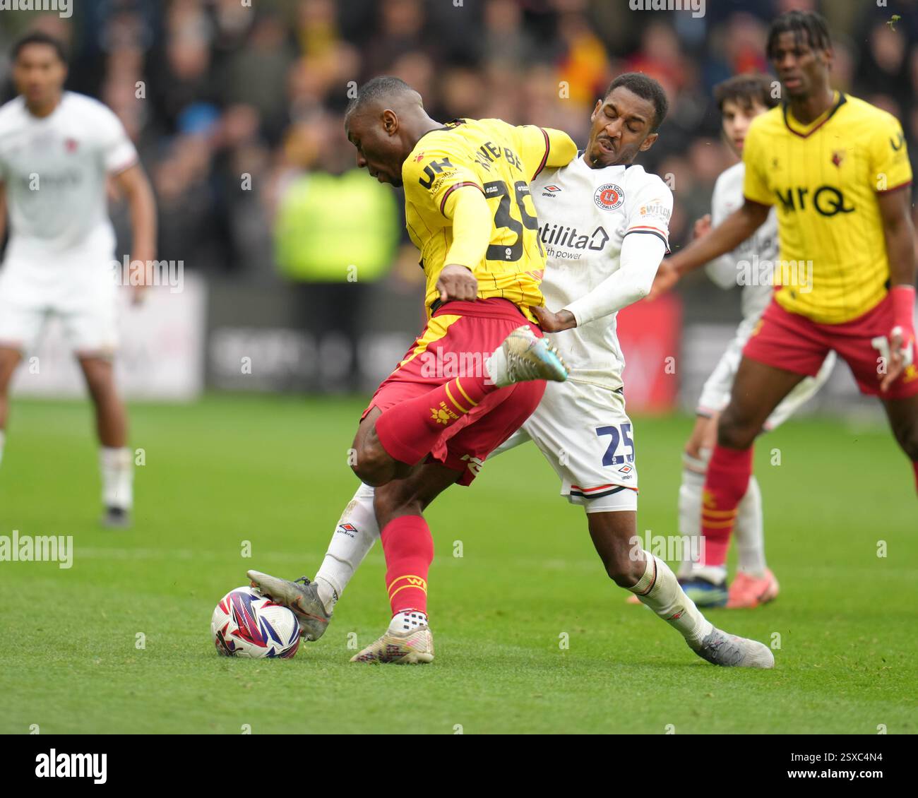 Isaiah Jones of Luton Town wins the ball off Edo Kayembe of Watford ...