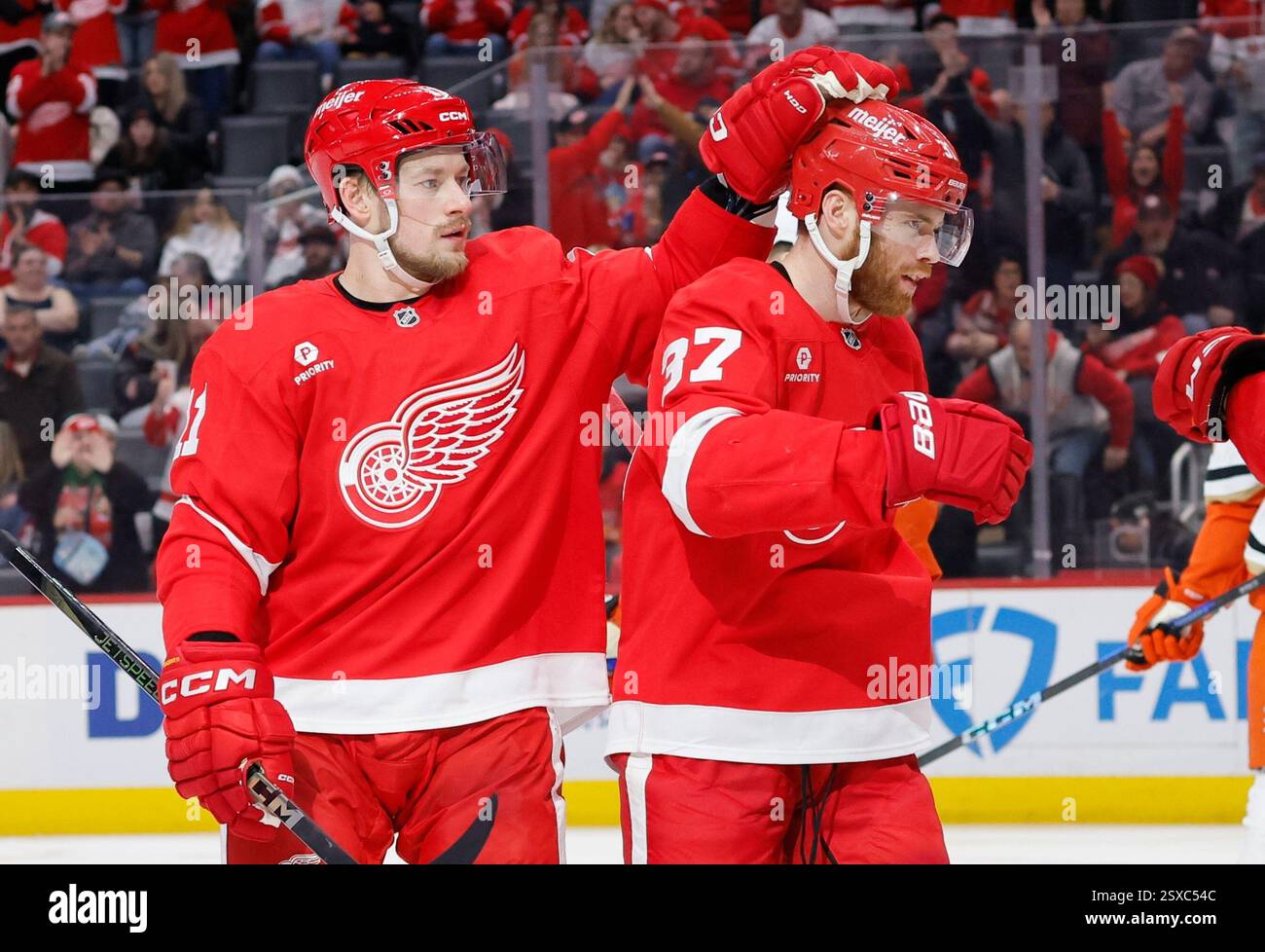 Detroit Red Wings left wing J.T. Compher is congratulated by right wing ...