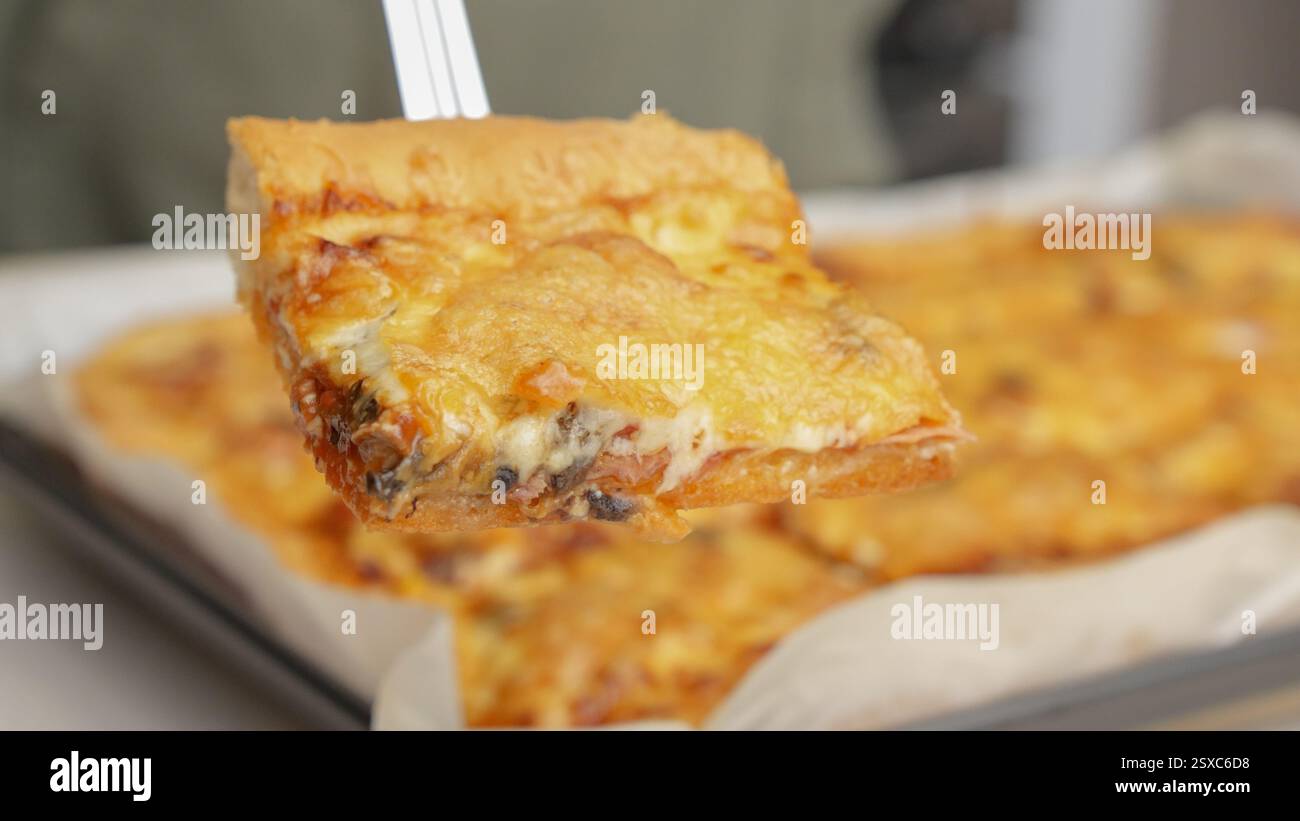 Homemade square pizza with cheese and sausage topping served on wooden ...