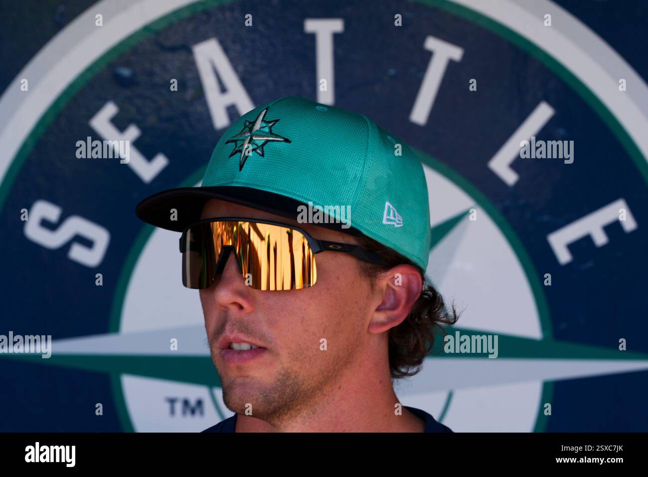 Seattle Mariners starting pitcher Logan Gilbert sits in the dugout ...