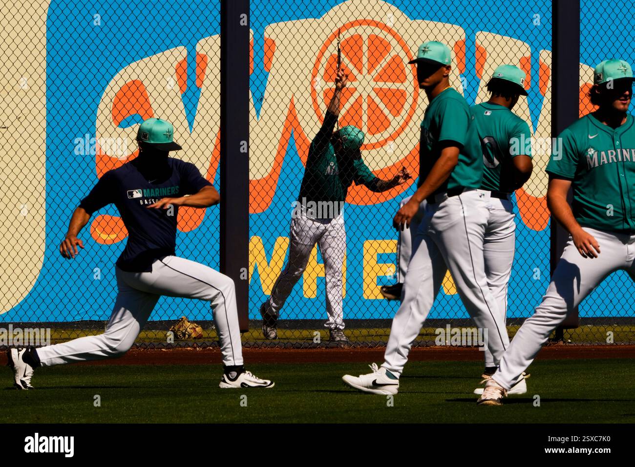 Seattle Mariners players warm up in the outfield and bullpen before a ...