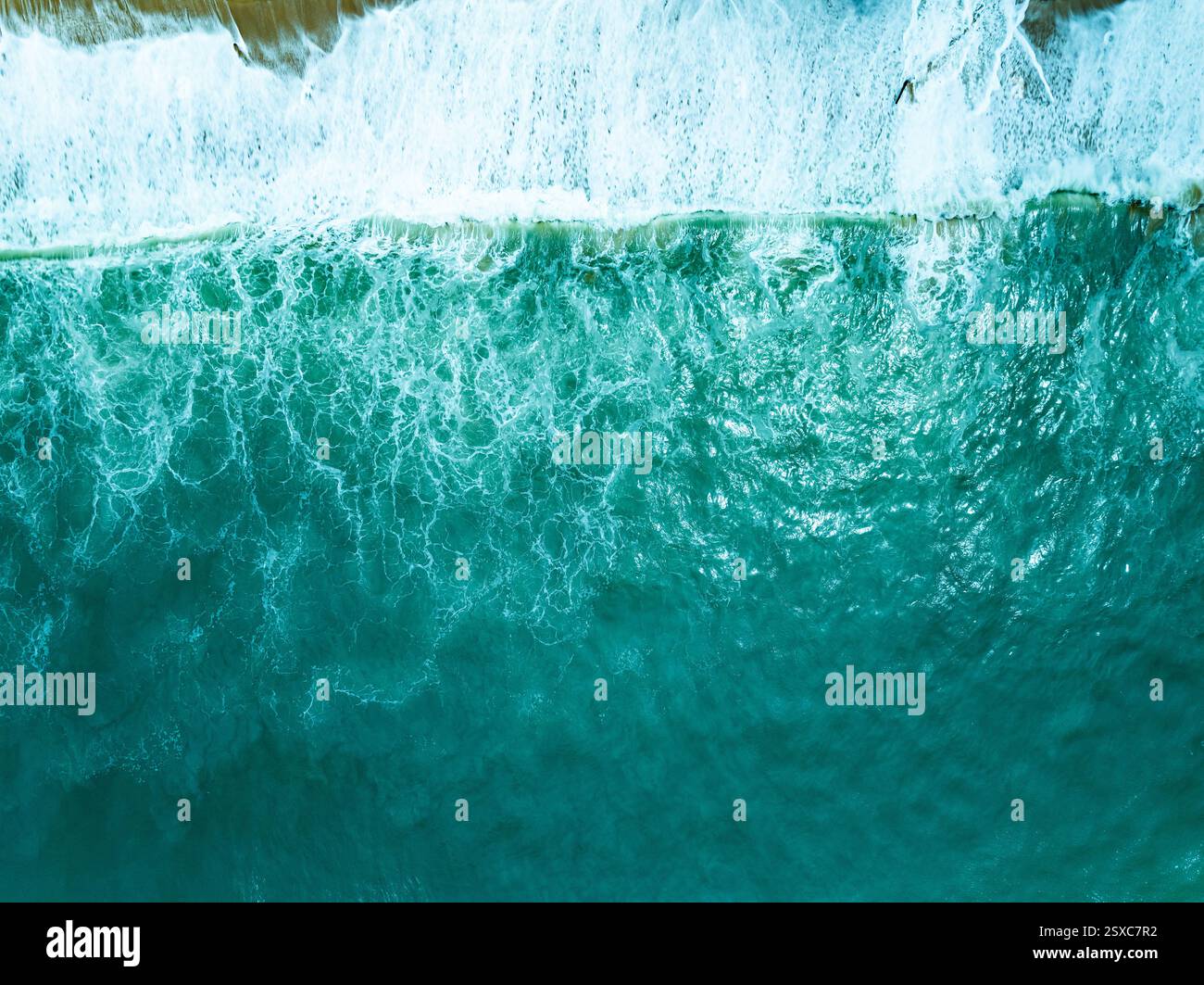 Overhead view turquoise stormy ocean waves with white foam in the ocean ...