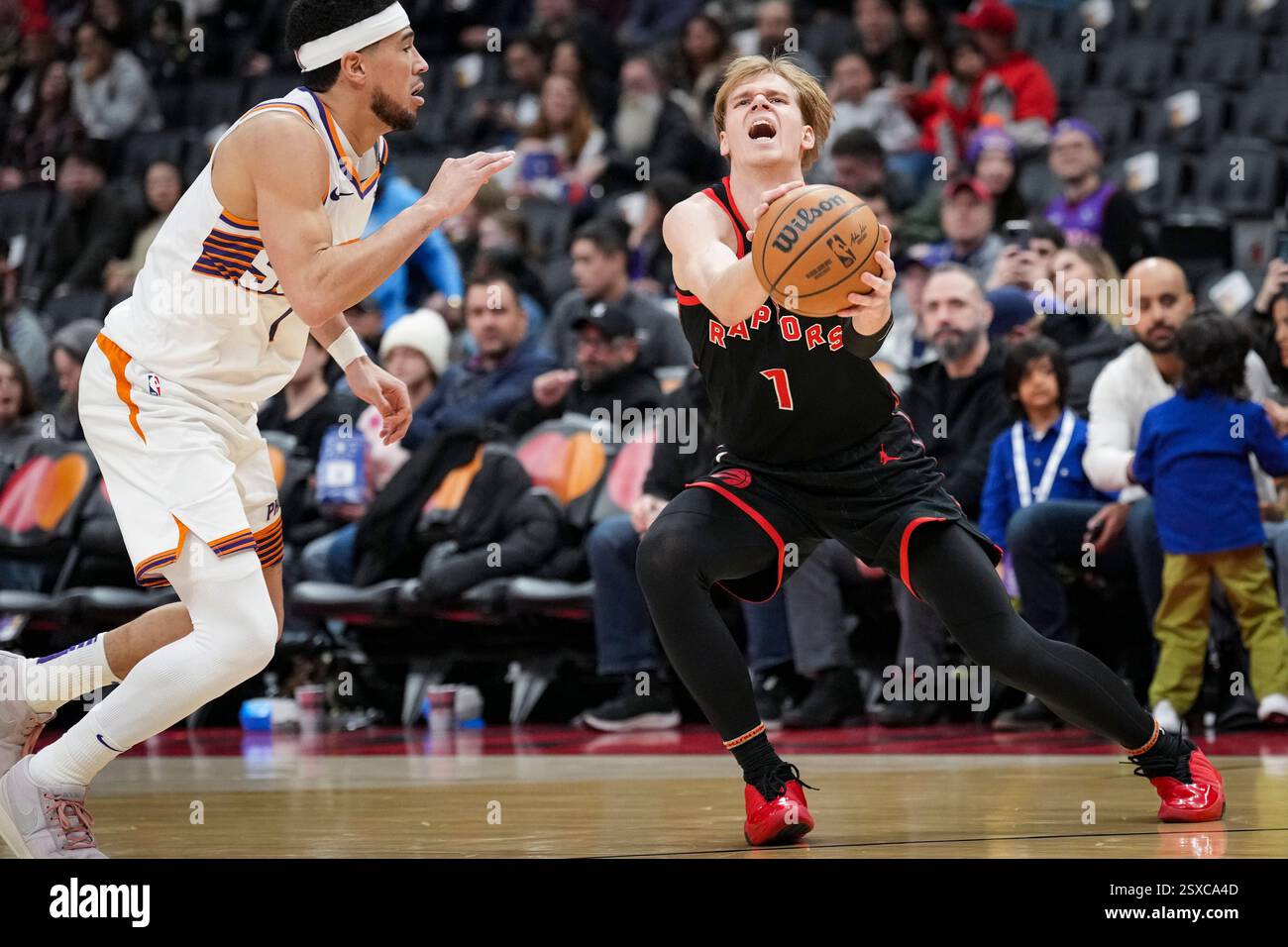 Phoenix Suns guard Devin Booker, left, guards against Toronto Raptors ...