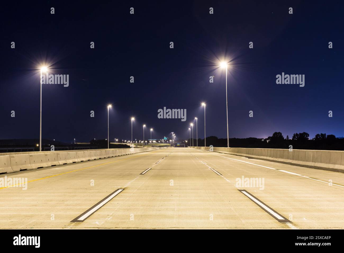Long road with many street lights. The road is empty Stock Photo - Alamy