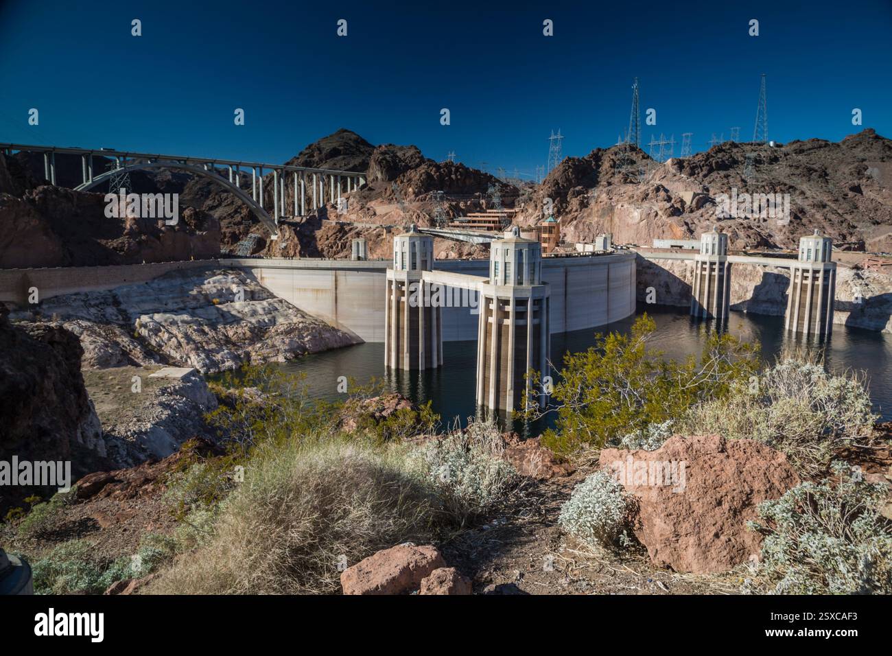 Large dam is in the middle of a desert. The dam is surrounded by a ...