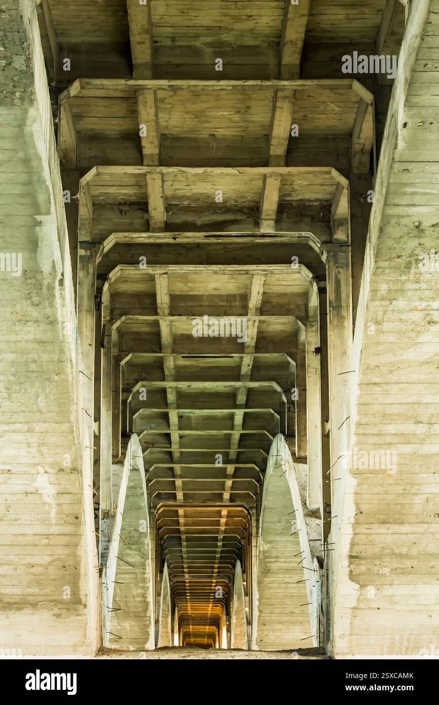 Long, narrow bridge with a series of arches. The arches are made of ...