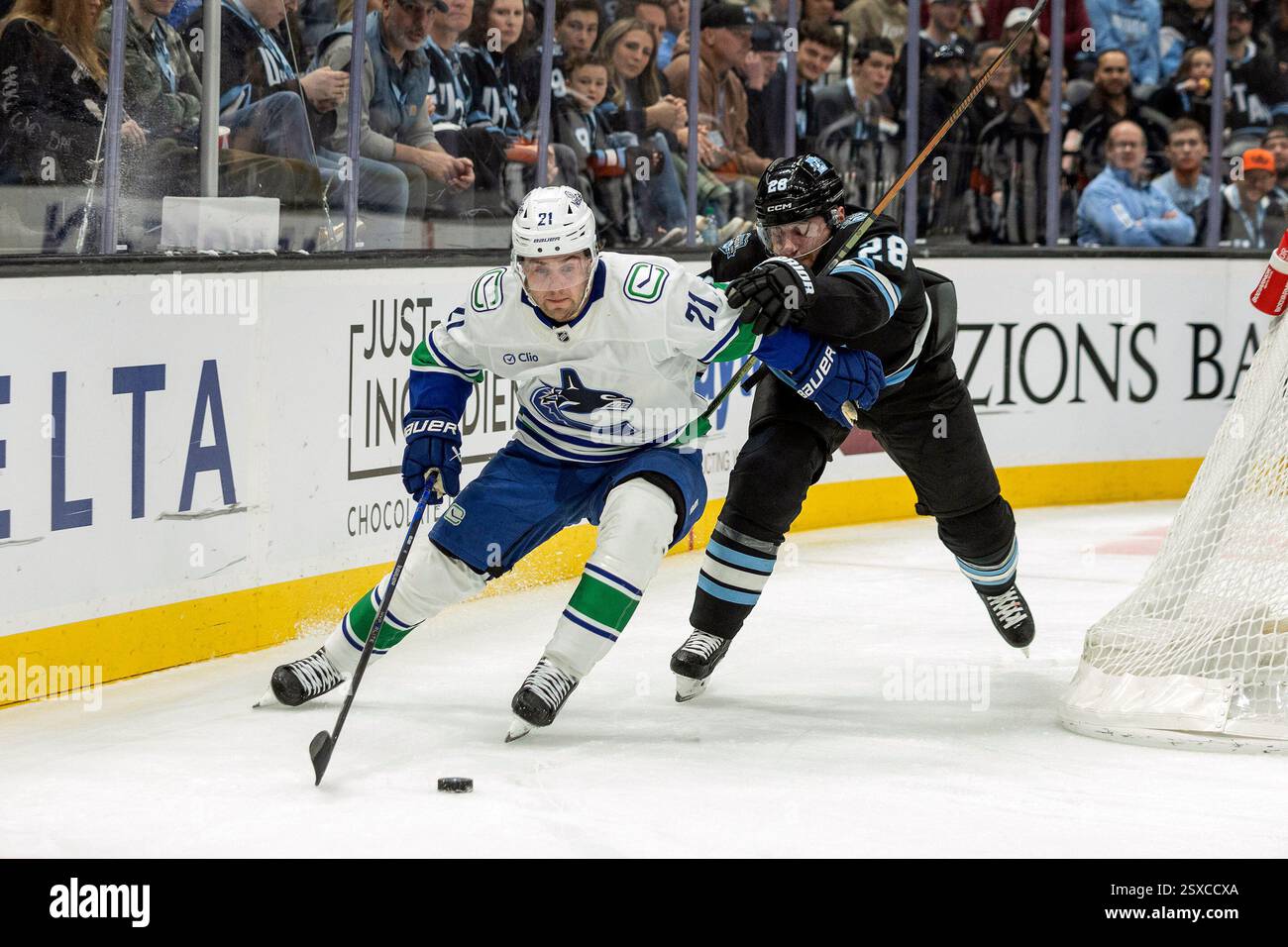 Vancouver Canucks left wing Nils Hoglander (21) moves the puck against ...