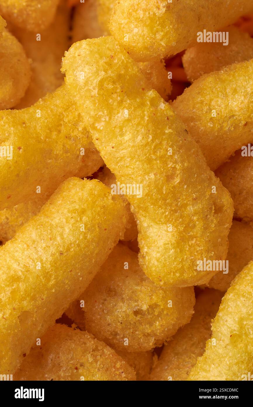 close-up macro view of crispy and spicy masala mix chips or yellow airy ...