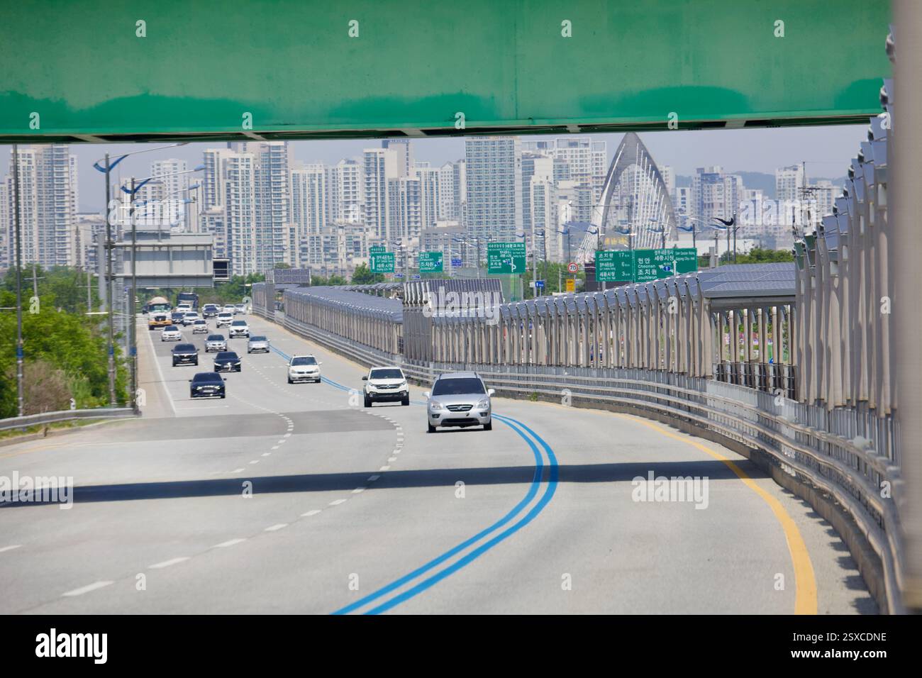 Sejong City, South Korea - May 26, 2021: Vehicles travel along North Star Road while a solar ...