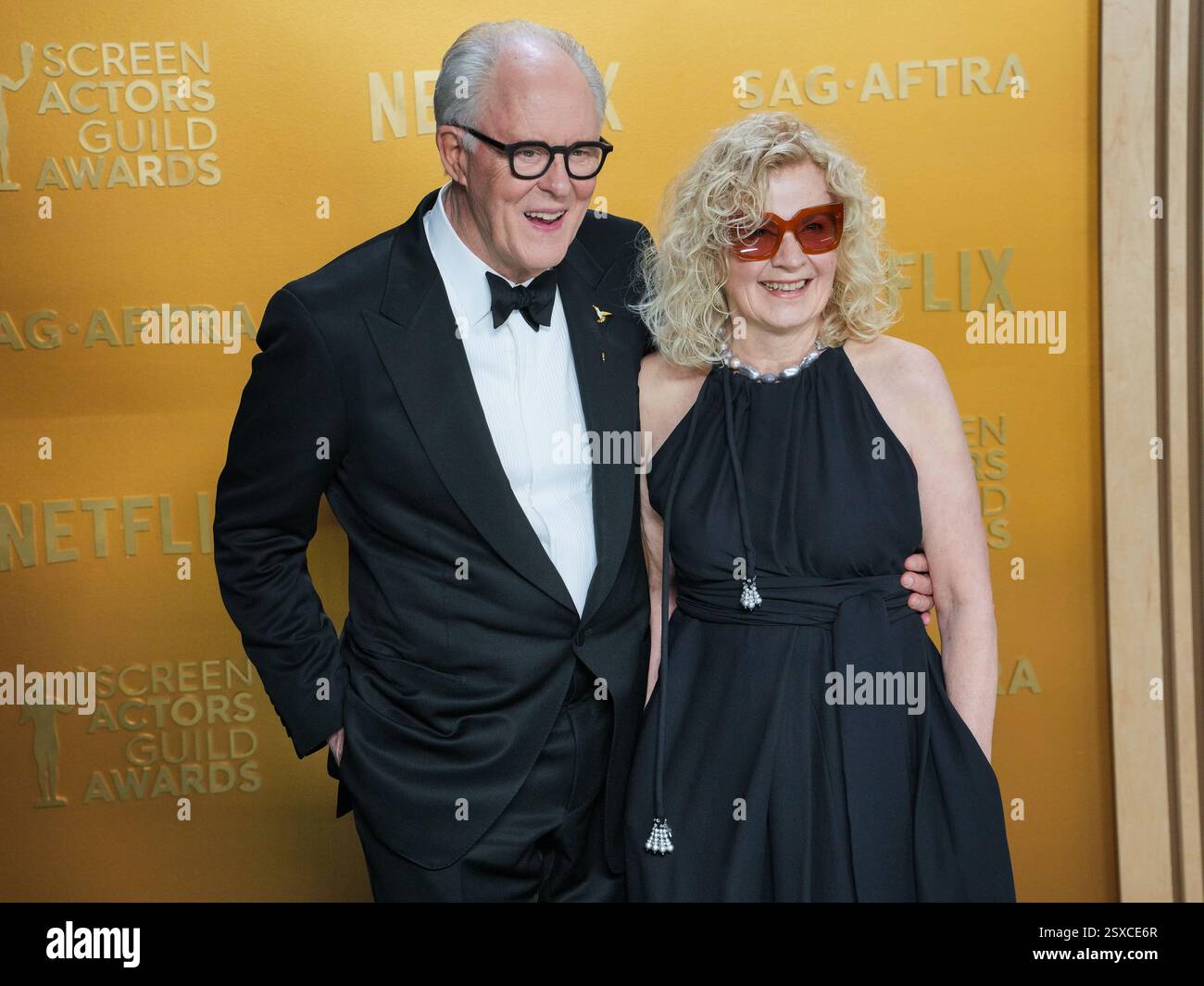 John Lithgow and Mary Yeager walking on the red carpet at the 31st ...