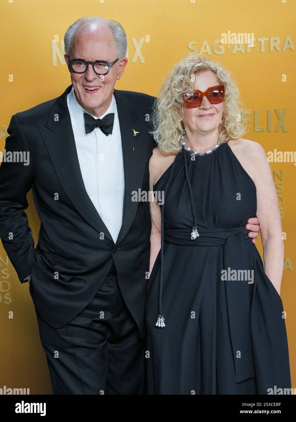John Lithgow and Mary Yeager walking on the red carpet at the 31st ...