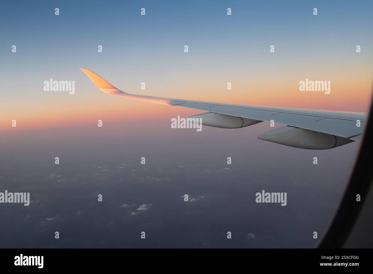 Airplane window view of sunset overlooking Doha, Qatar Stock Photo - Alamy