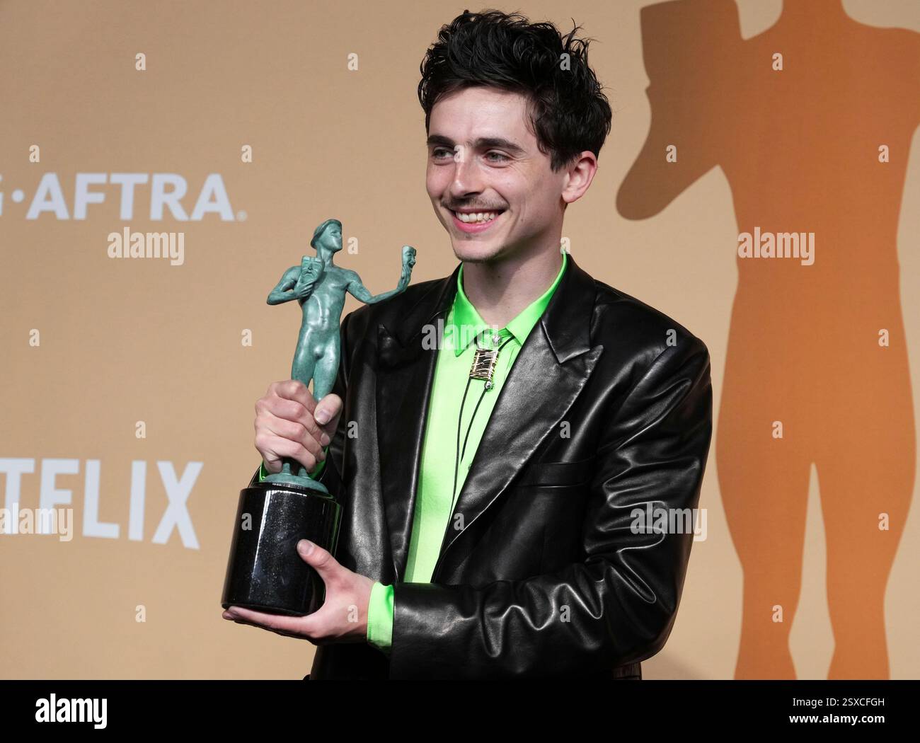 Timothee Chalamet poses in the press room with the award for outstanding performance by a male ...
