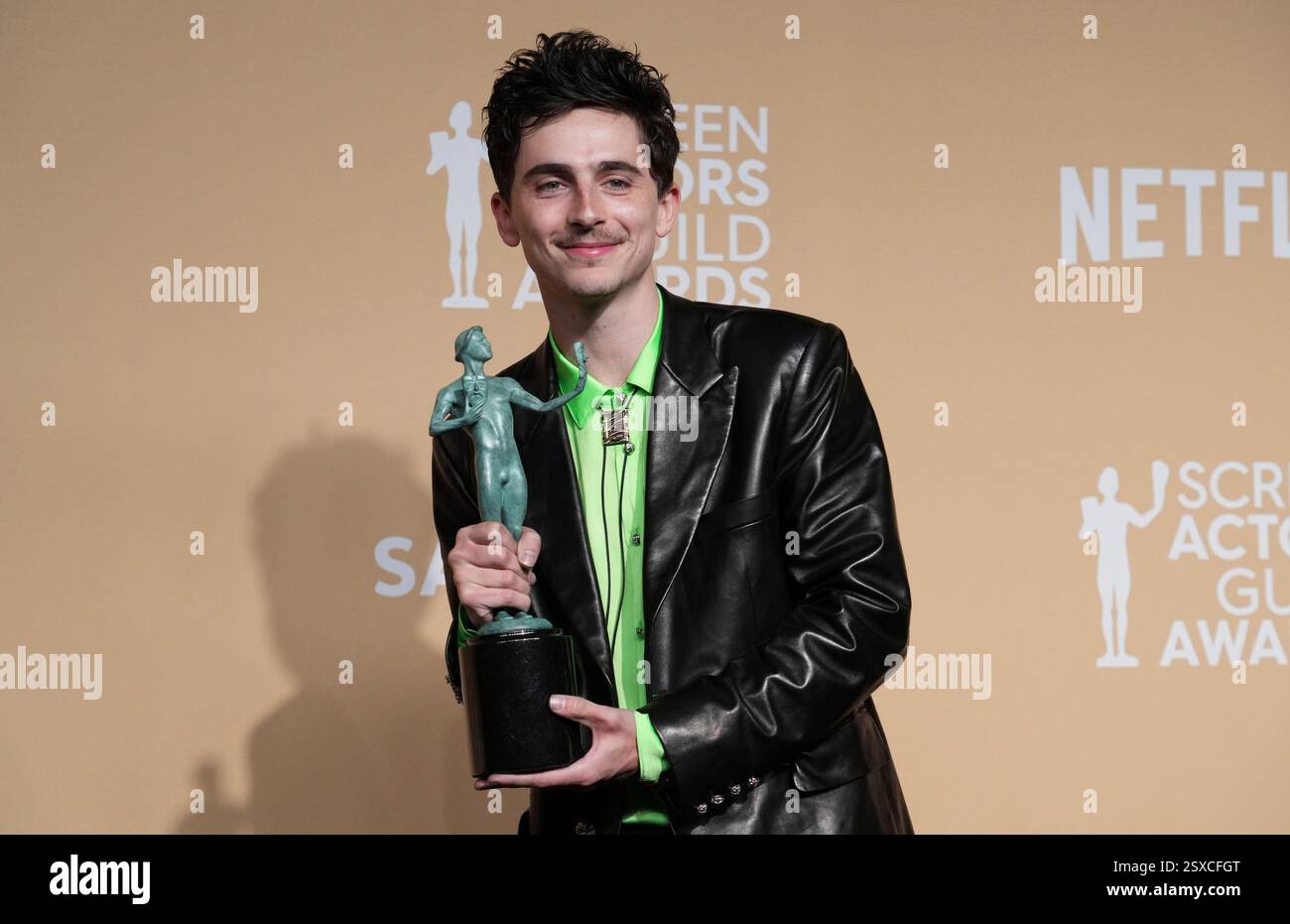 Timothee Chalamet poses in the press room with the award for outstanding performance by a male ...