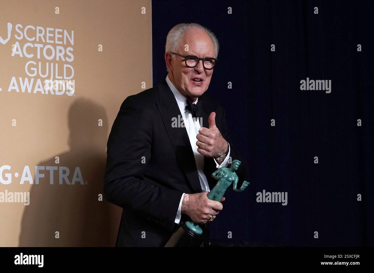 John Lithgow poses with the award for outstanding performance by a cast ...