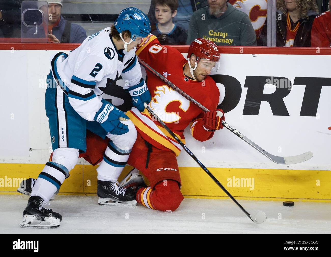 San Jose Sharks' Will Smith, left, checks Calgary Flames' Jonathan ...