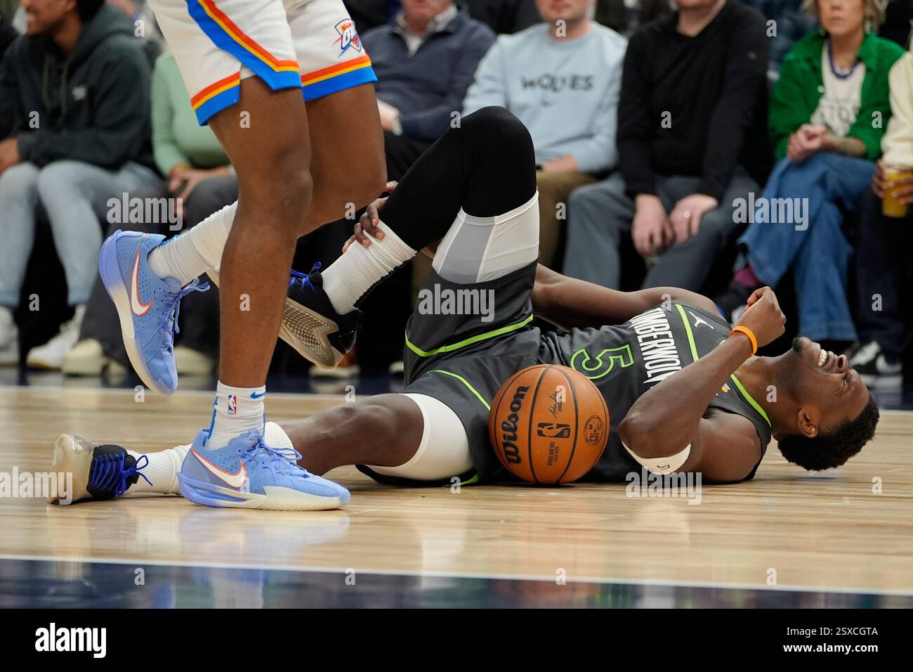 Minnesota Timberwolves guard Anthony Edwards (5) grabs his leg during ...