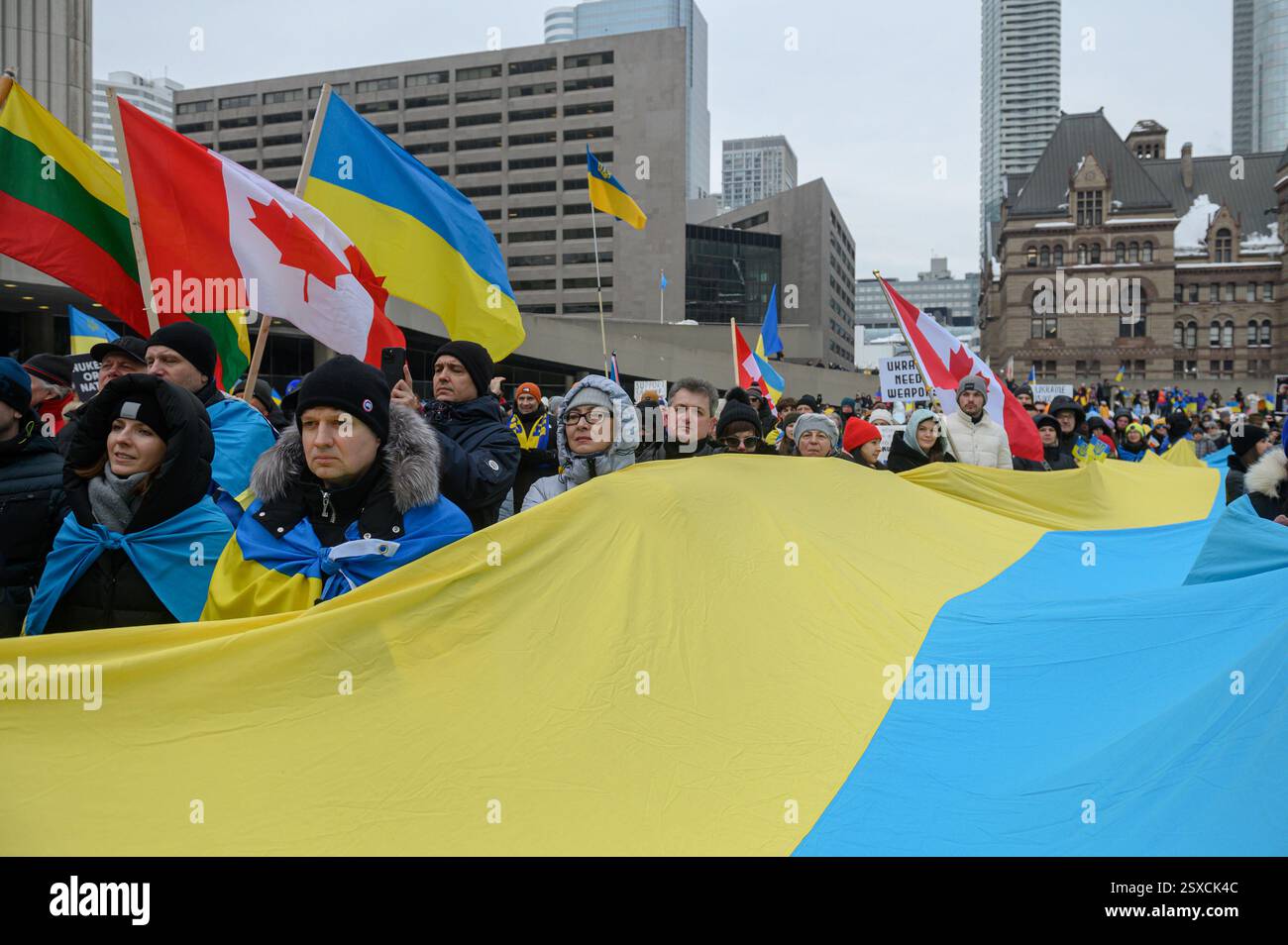Toronto, ON, Canada – February 23, 2025: People hold a big flag during ...