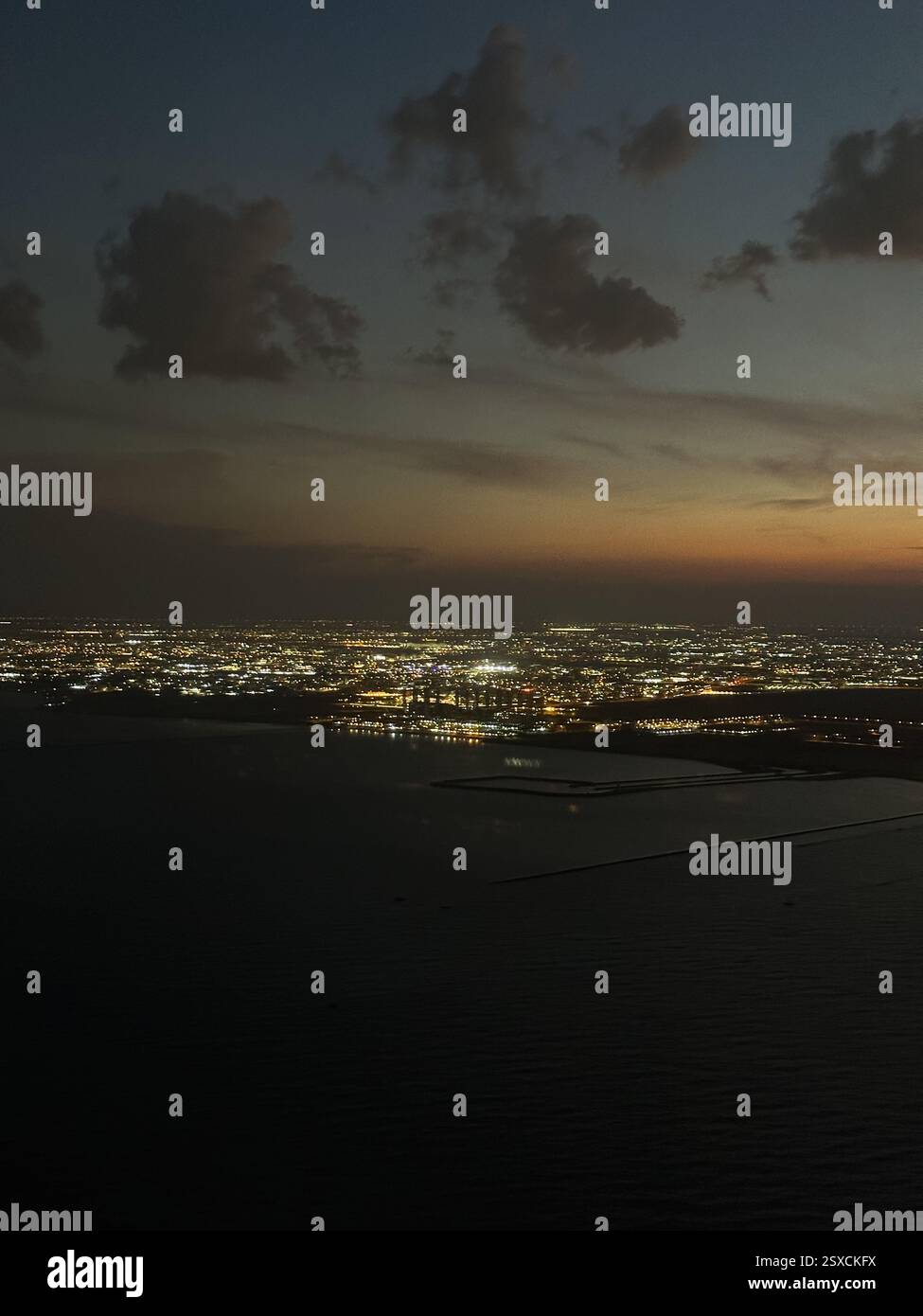Airplane window view of sunset overlooking Doha, Qatar Stock Photo - Alamy