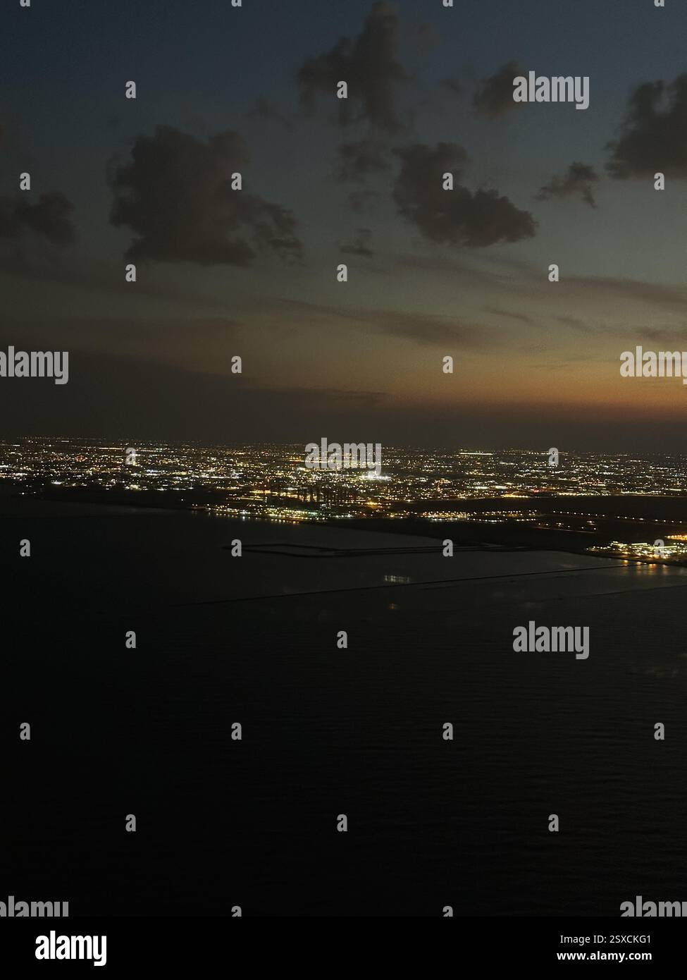 Airplane window view of sunset overlooking Doha, Qatar Stock Photo - Alamy
