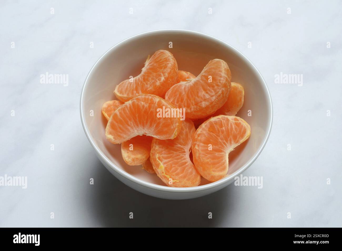 Clementine pieces in peel, clementine Stock Photo - Alamy