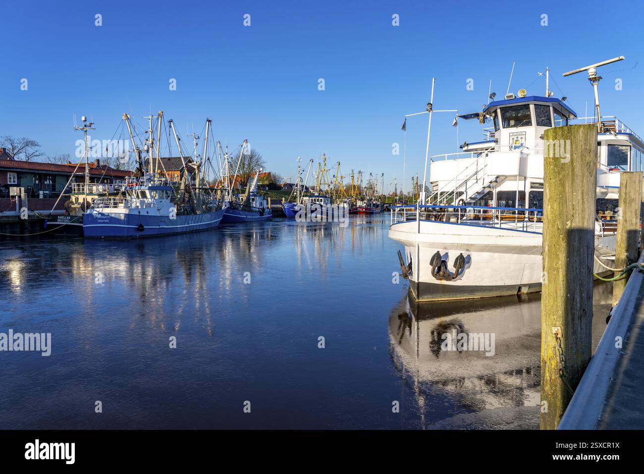 The fishing village of Greetsiel, historic fishing harbour, with the ...