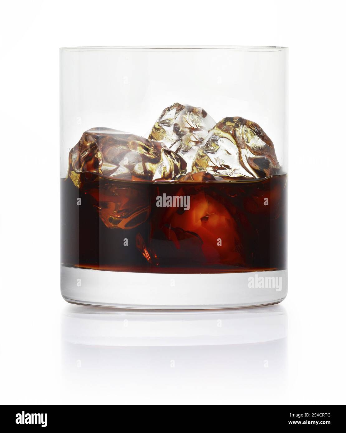 Drink on ice cube cubes in a tumbler in front of a white background ...
