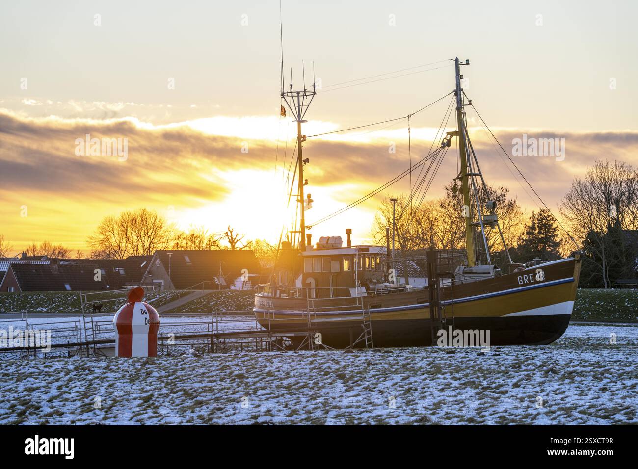 The fishing village of Greetsiel, historic fishing harbour, with the ...