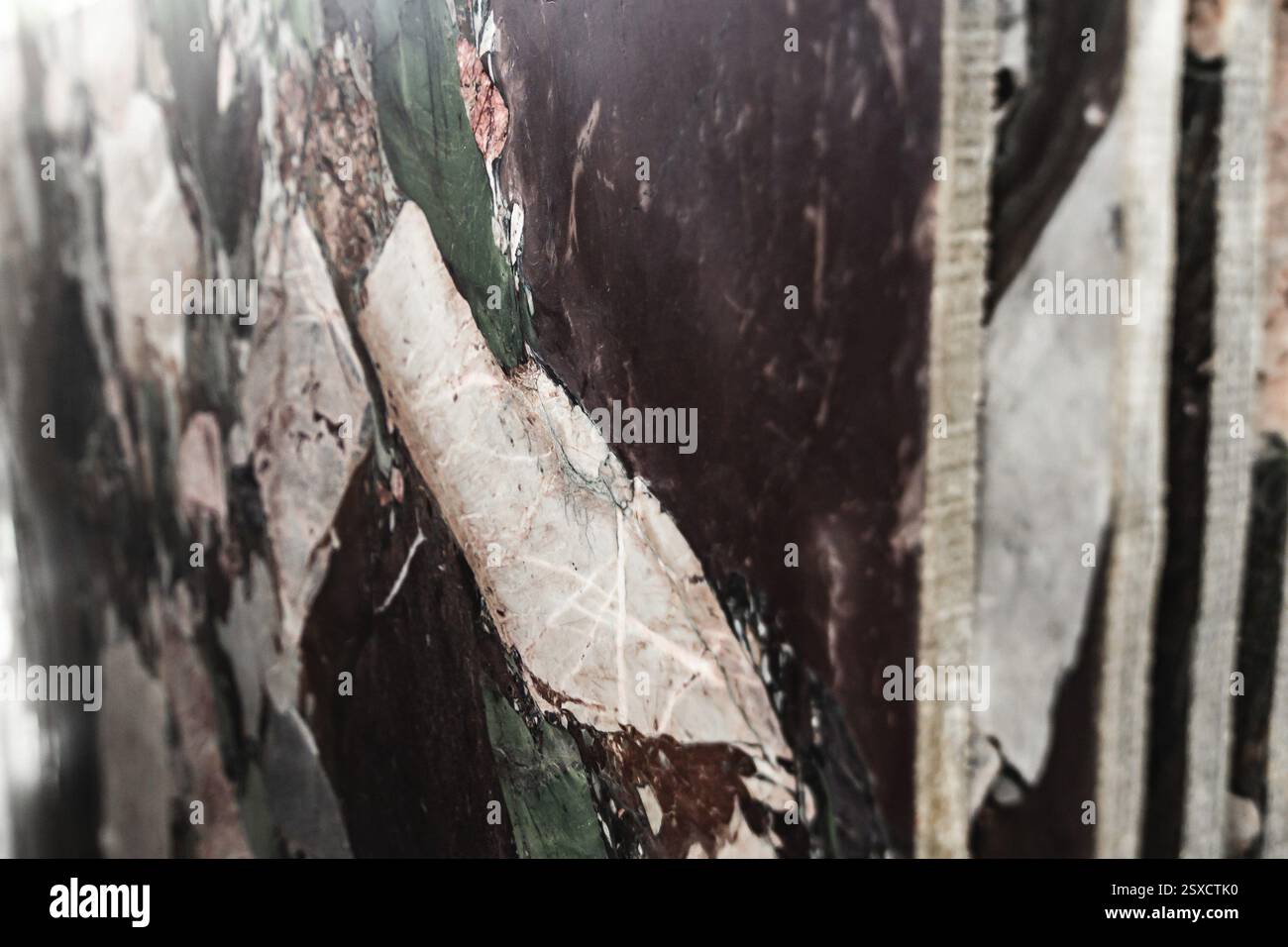 Close view of a layered stone surface with dark and green colors, stone ...