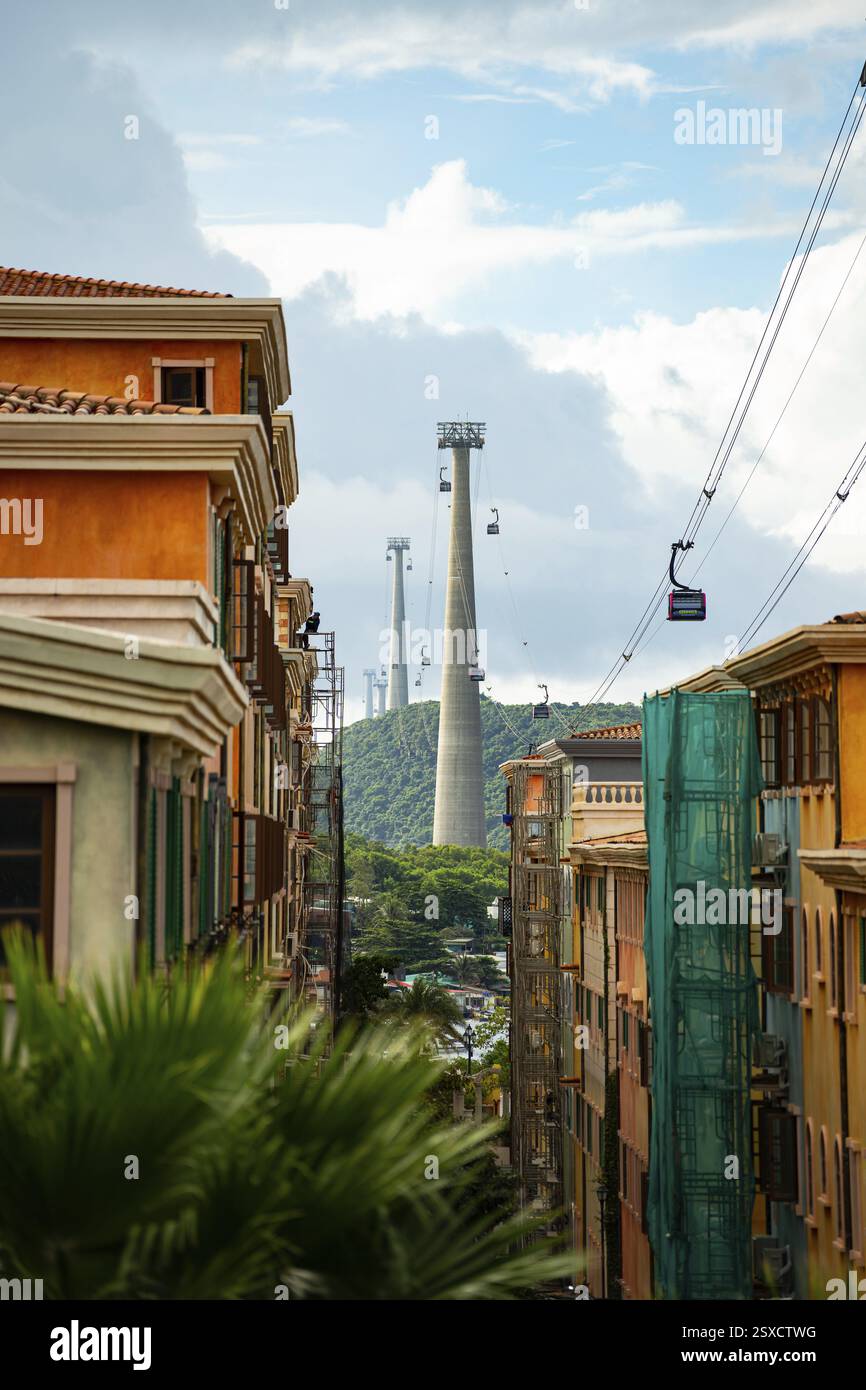 Cable car and colorful buildings with a view of mountains and palm ...