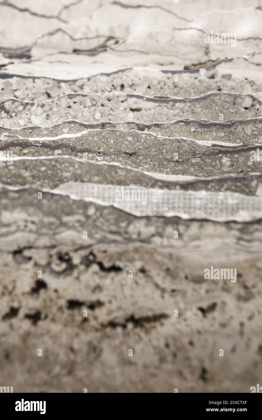 Stone texture featuring varied gray and white layers with a rough ...