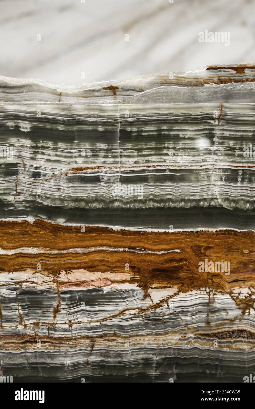 Detailed view of marble layers in green, rust, and white tones with a ...