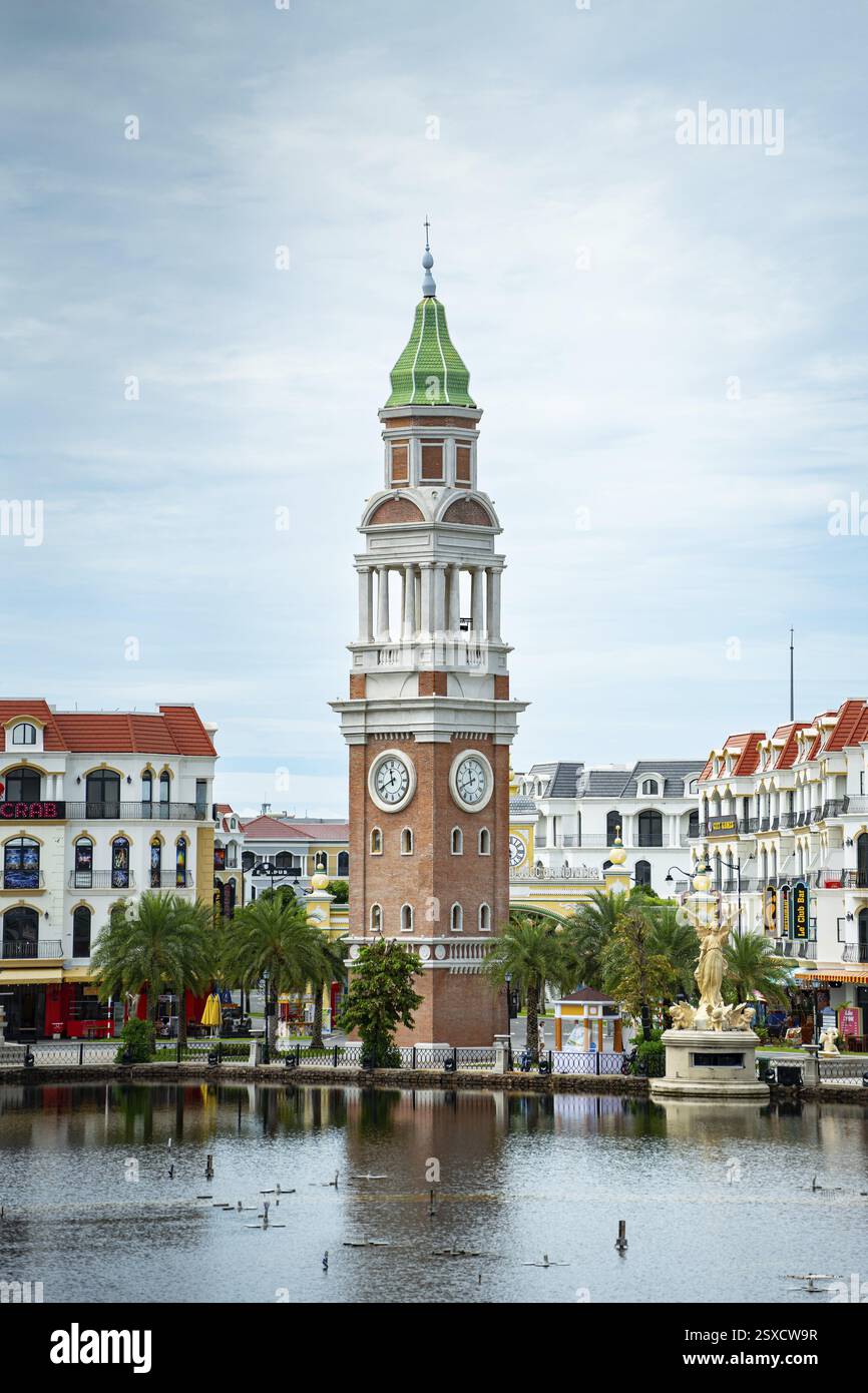 A clock tower with a green roof stands by a plaza with palm trees and ...