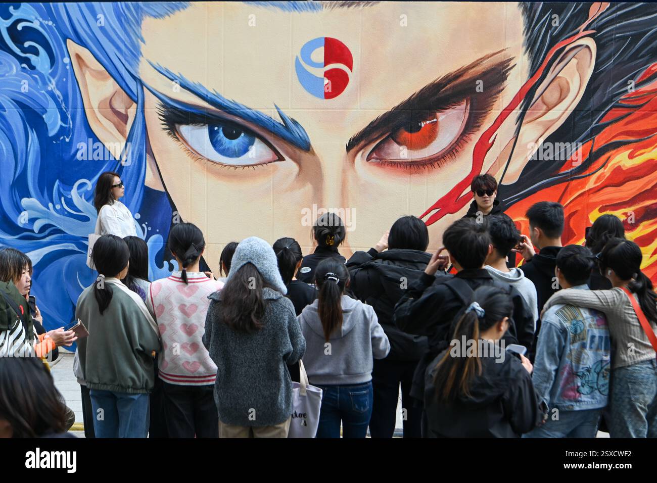 Kunming,China.23th February 2025. Visitors look at hand-painted cartoon ...