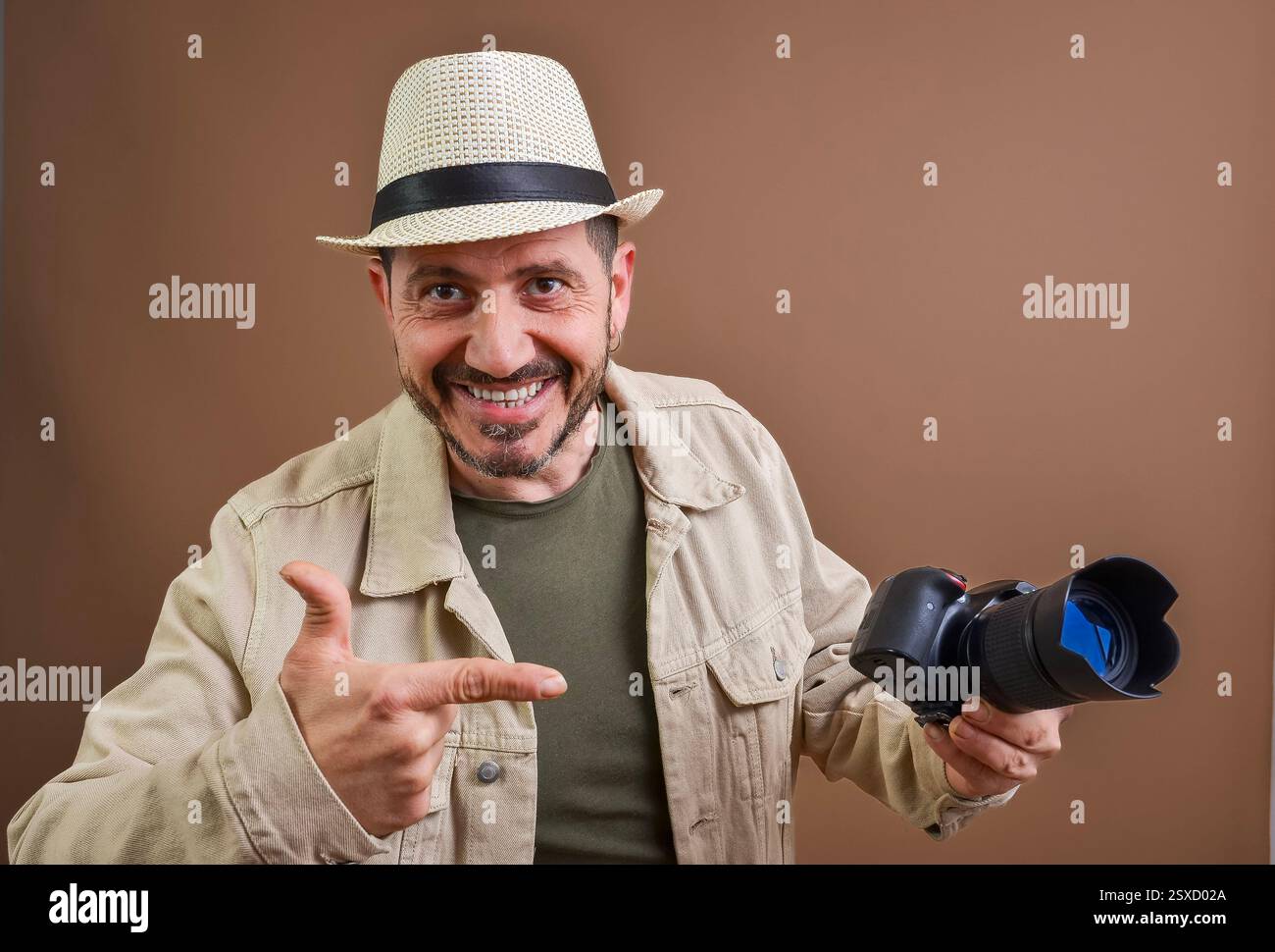 Photographer showing professional camera with big lens pointing at it ...