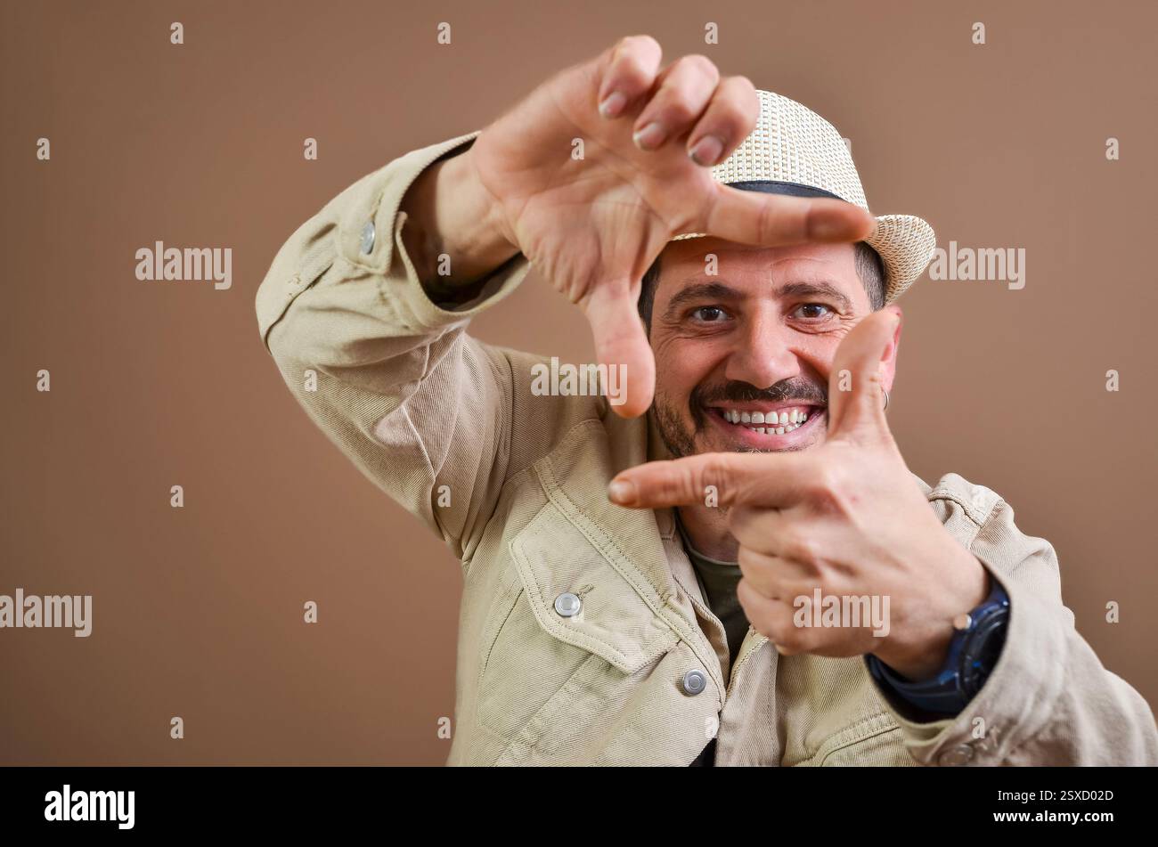 Happy tourist wearing summer hat framing with hands and smiling ...