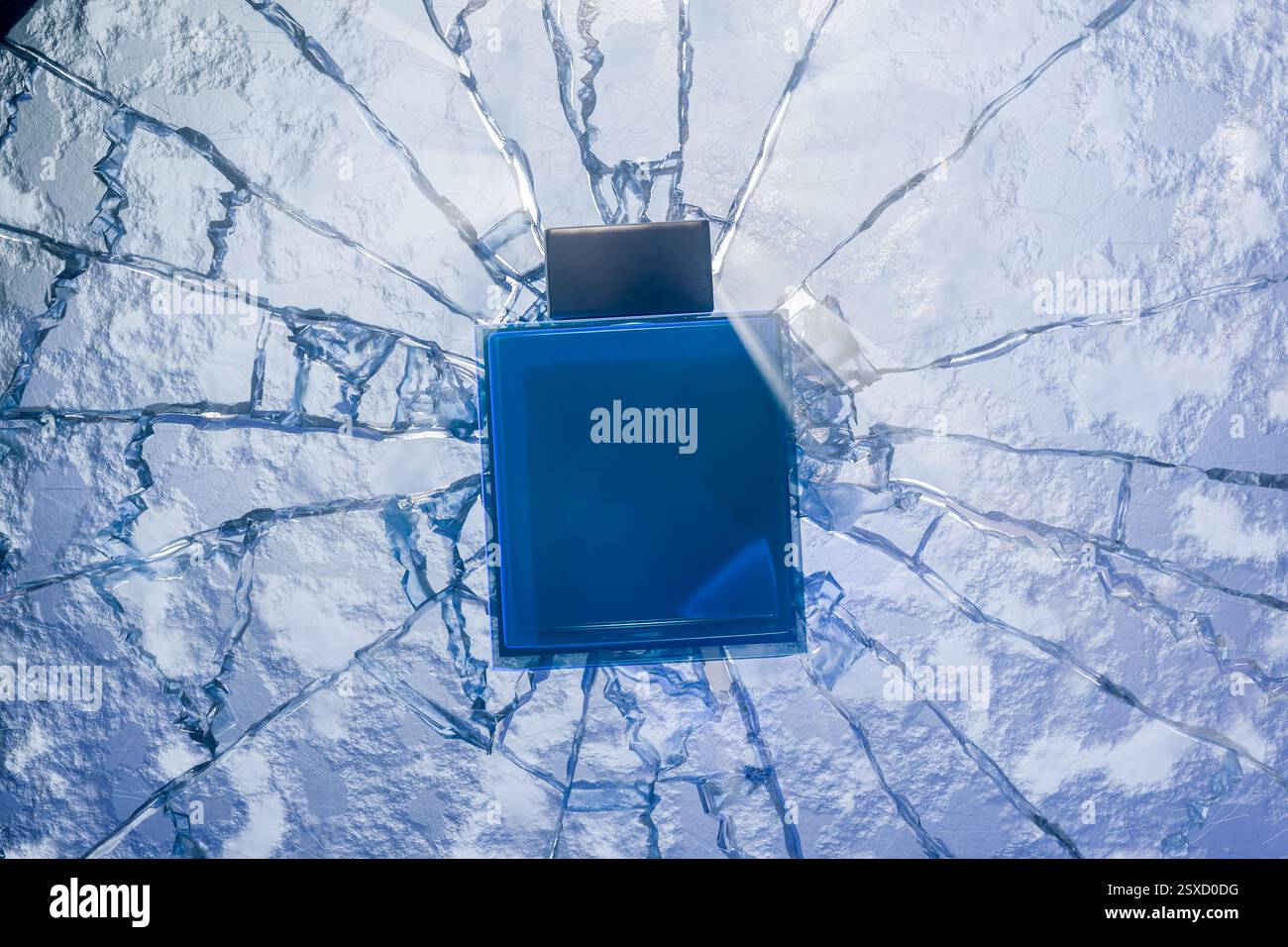 Blue men perfume bottle on cracked glass surface, elegant fragrance ...