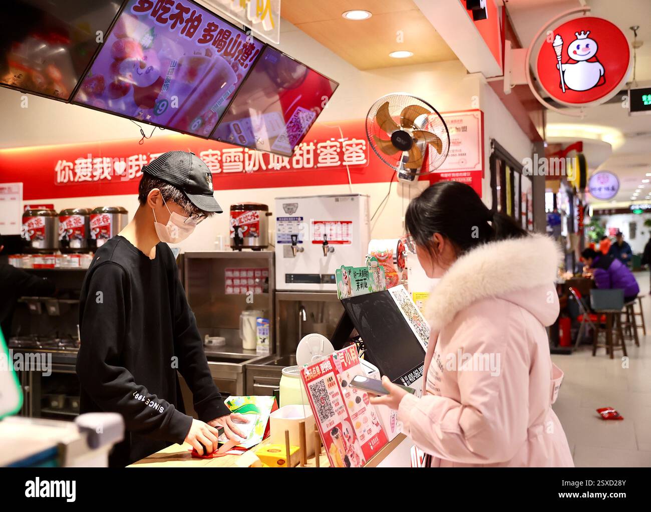Beijing,China.21th February 2025. Consumers buy beverages outside a ...