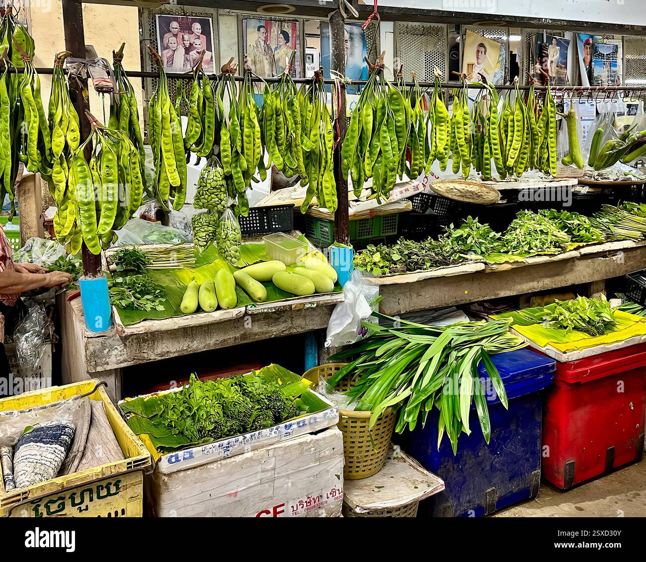Fresh Vegetable and Herb Market in Thailand A stall filled with green ...